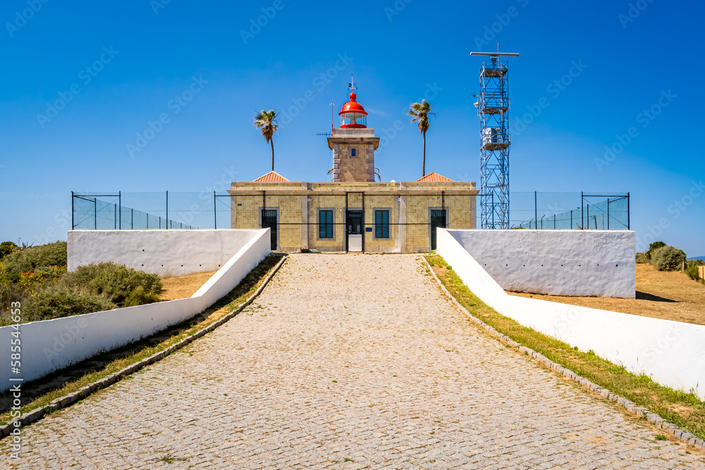 Backside view of the fenced lighthouse Farol da Ponta da Piedade from ...