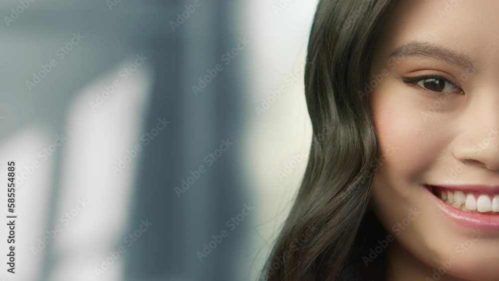 Beautiful face of pretty chinese girl posing indoors on blurred grey ...