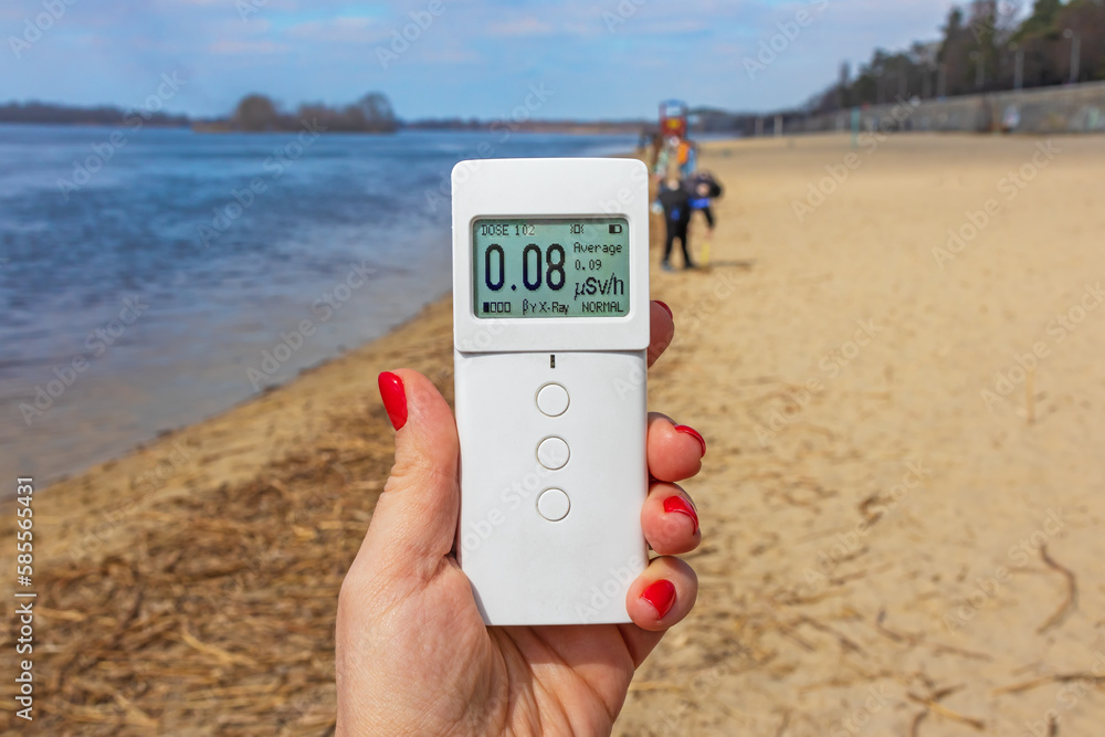 Modern device dosimeter radiometer in hand. Measurement of the level of ...
