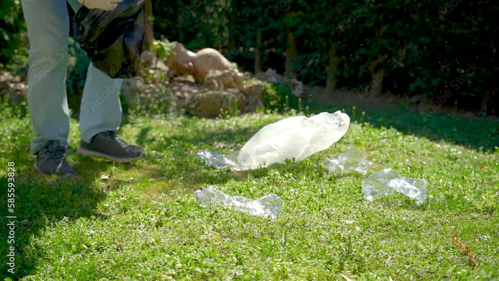 Man activist clean up littering rubbish at the public park, promote ...