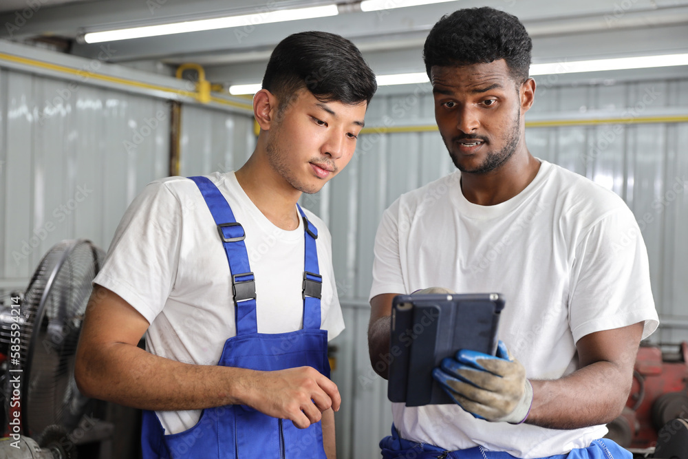 Multiethnic technicain mechanic or worker in half uniform using metal ...