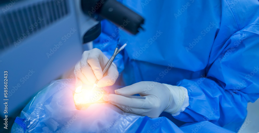 Surgeon or doctor in blue uniform did microsurgery inside operating ...