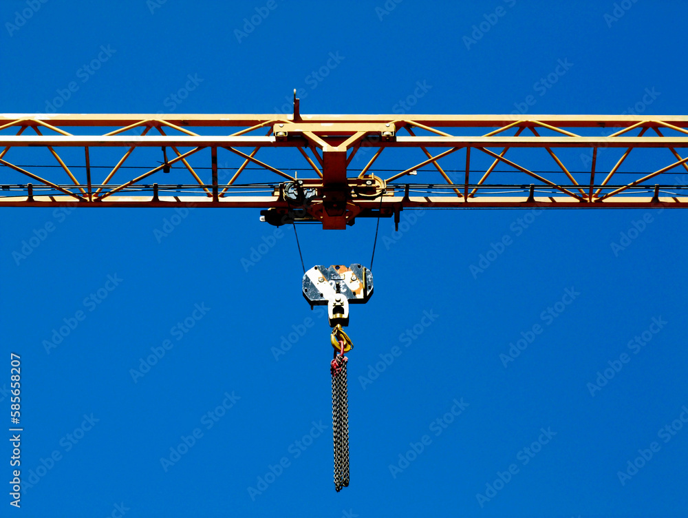 yellow steel truss crane boom closeup. clear blue sky. building ...