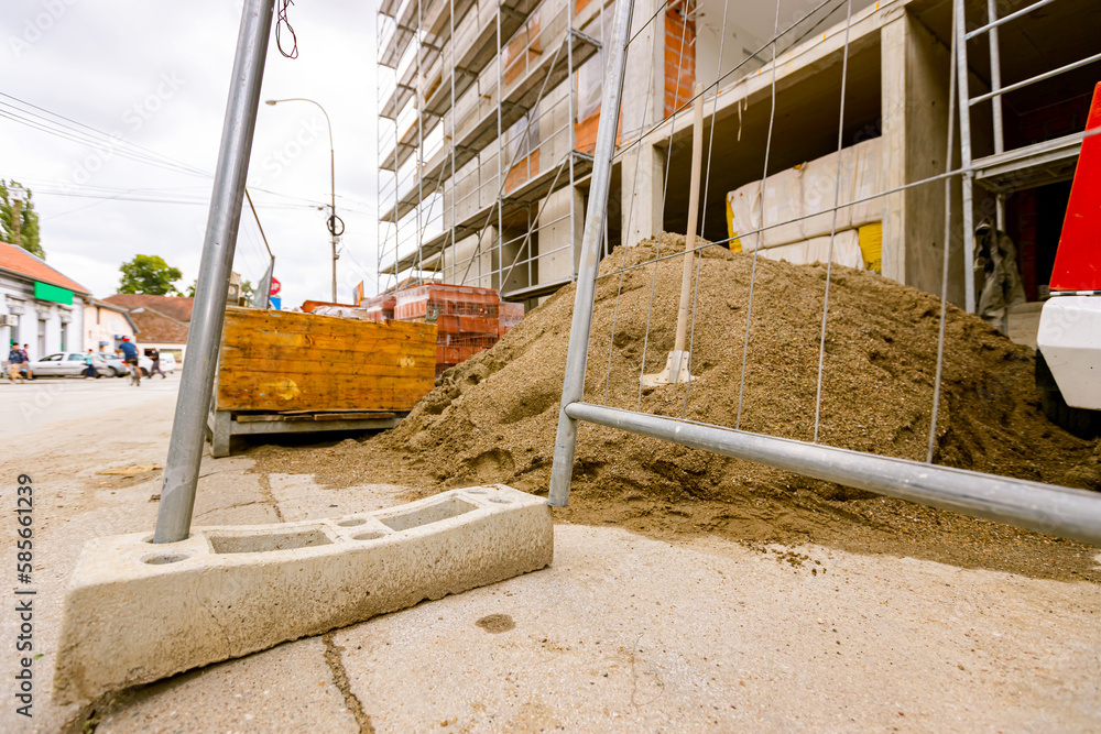 Entrance at the construction site. Concrete foot stabilizer for metal ...