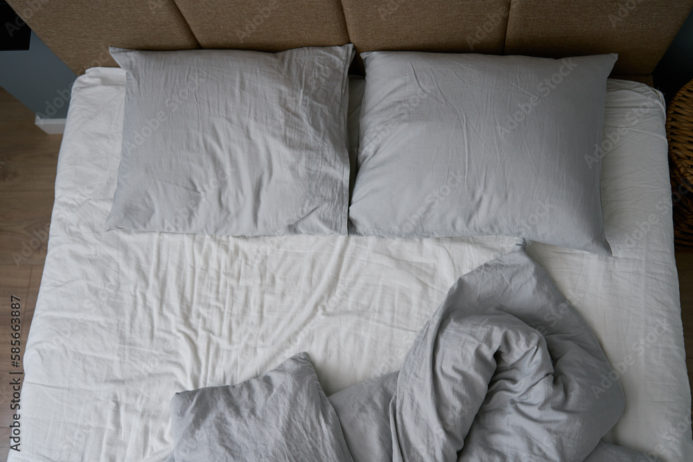 Unmade bed after sleeping. Crumpled bed with pillows, blanket and ...