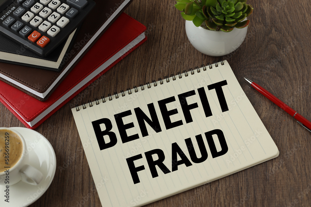BENEFIT FRAUD text in notepad on with calculator on desktop Stock Photo ...