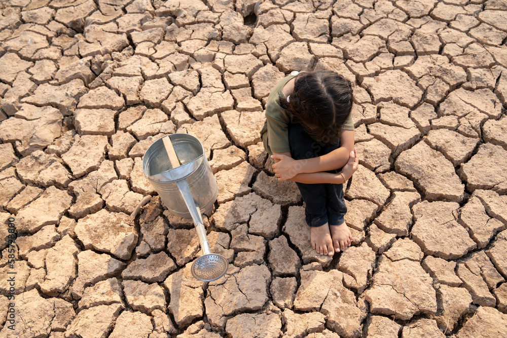 Sad kids are sitting on cracked earth open metal water old faucet on ...