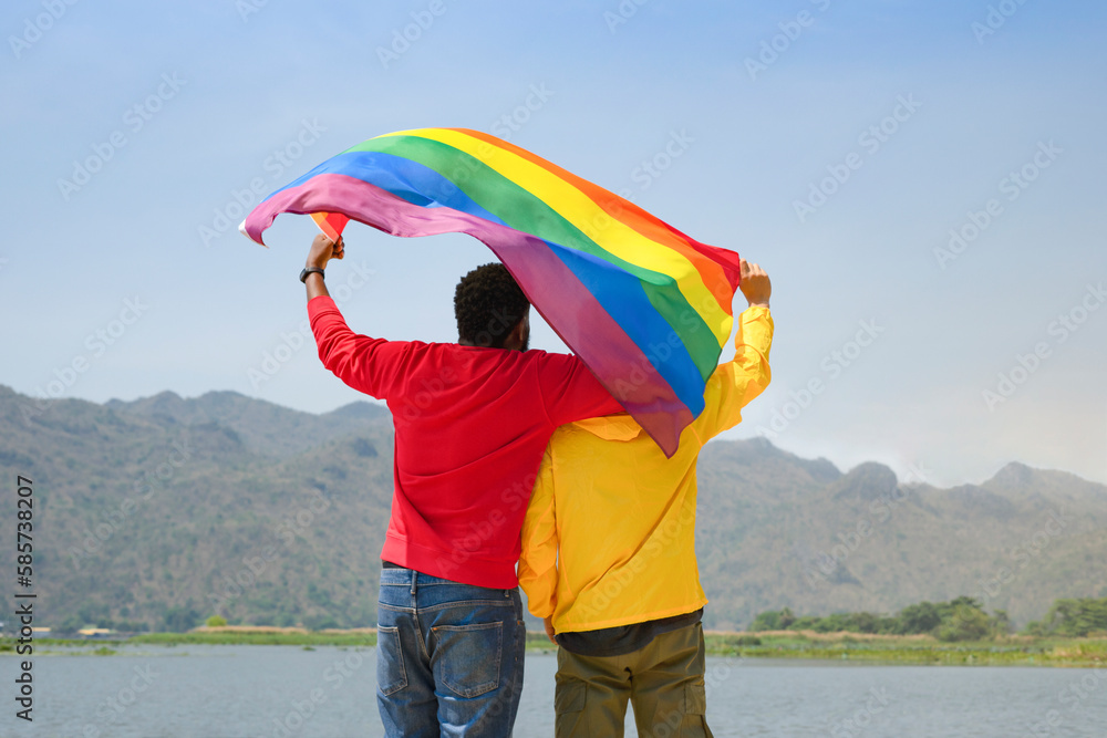 romantic gay couple wearing colorful clothes, standing side by side ...