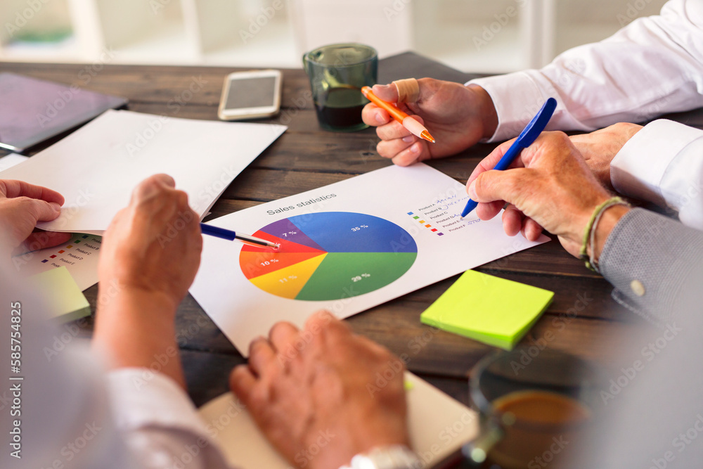 Business people analyzing charts during meeting Stock Photo | Adobe Stock