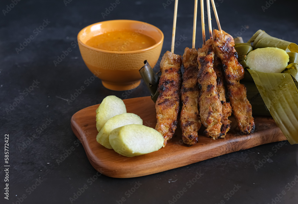 sate ayam or chicken satay with rice cake and peanut sauce Stock Photo ...