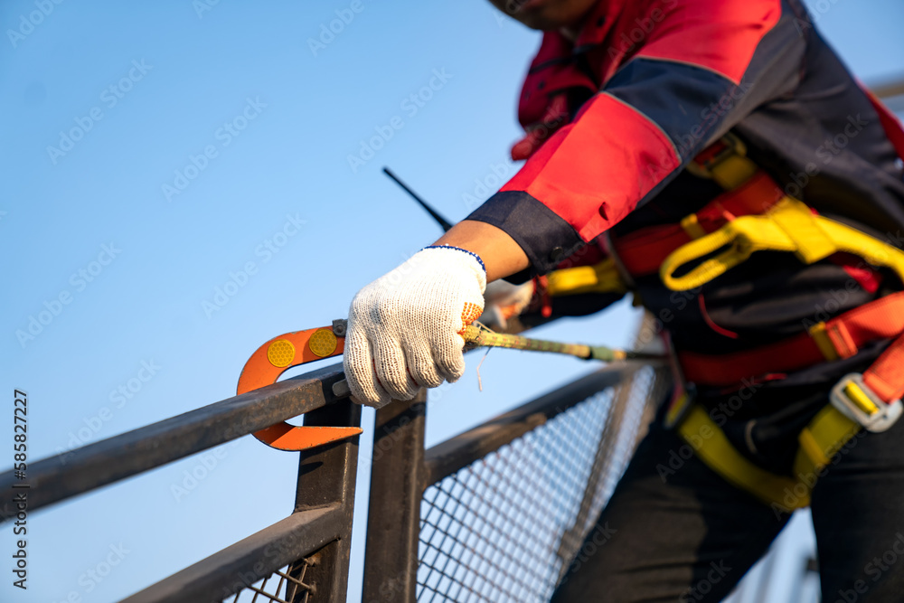 Construction worker use safety harness and safety line working on a new ...