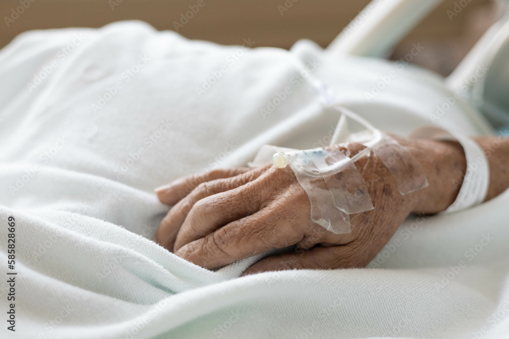 old patient hand with safety needle on back palm, senior man has health ...