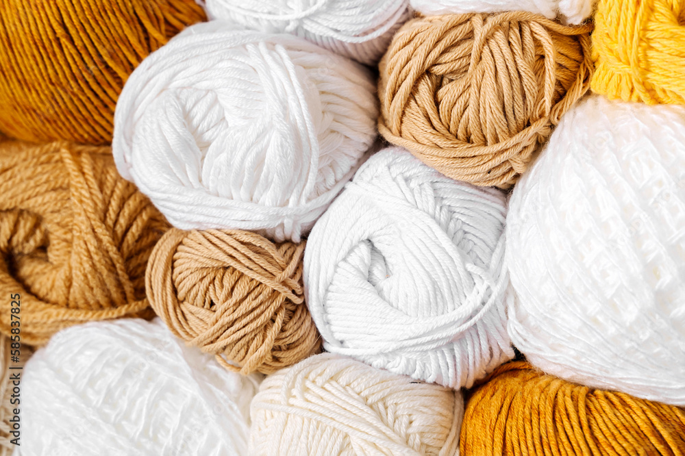 White shelving with colored balls of yarn for knitting. Bright yarn ...