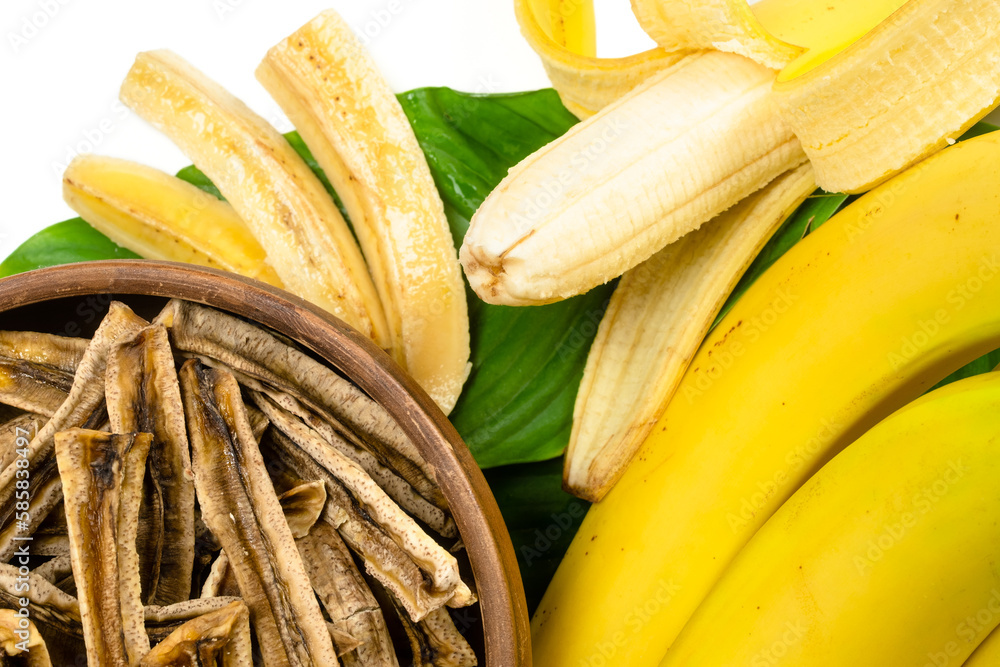 Dried bananas in the bowl and fresh bananas isolated on white ...
