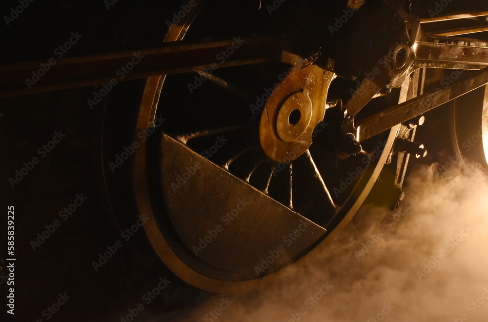 steam locomotive iron wheel with smoke floating on railway in night ...