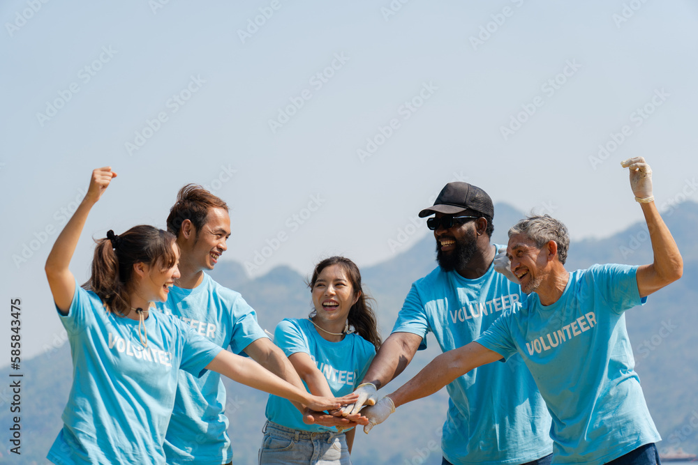 Group of happy multi-ethnic volunteers joining hands stack together and ...