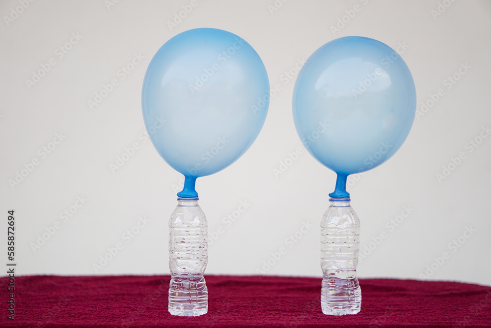 Blue inflated balloons on top of transparent test bottles. Concept ...