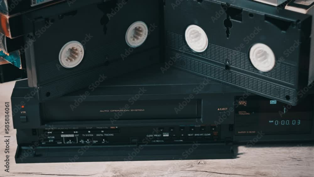 Male hand pulls out VHS from a vintage videotape recorder. Eject VHS ...