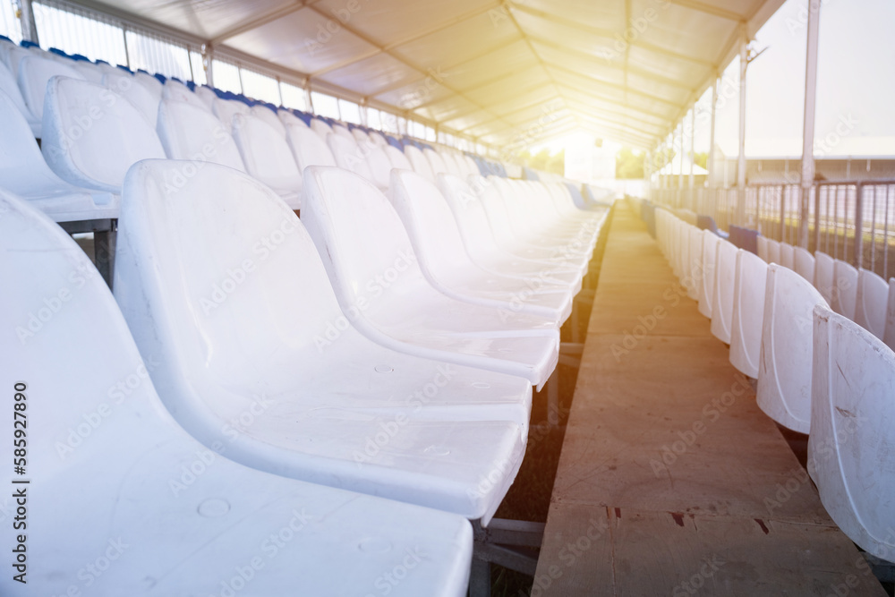Empty white seats of tribune on sport stadium. Many empty plastic seats ...