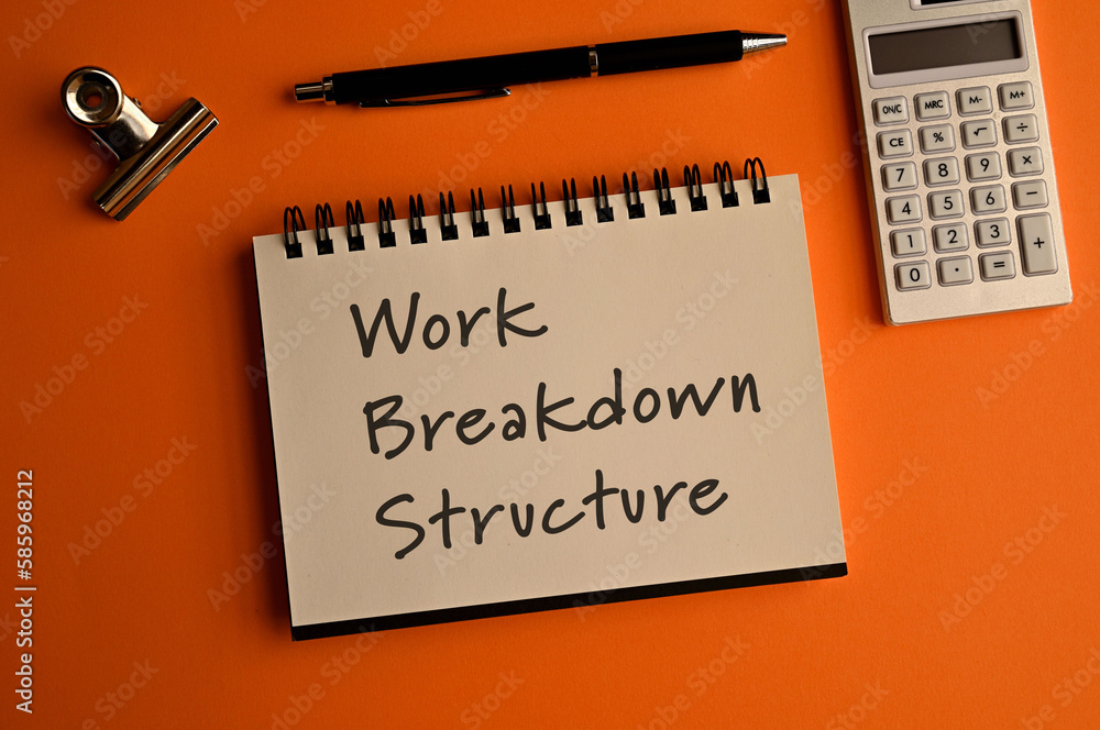 There is a notebook with the word Work Breakdown Structure. It is eye ...
