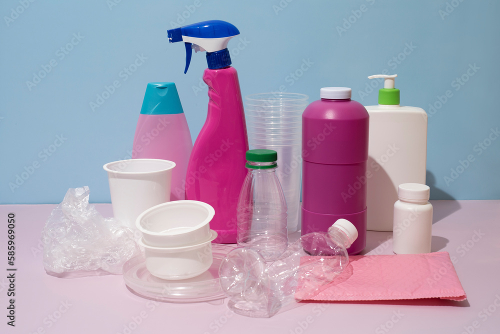 Still life of different types of plastic packaging of purple, pink and ...