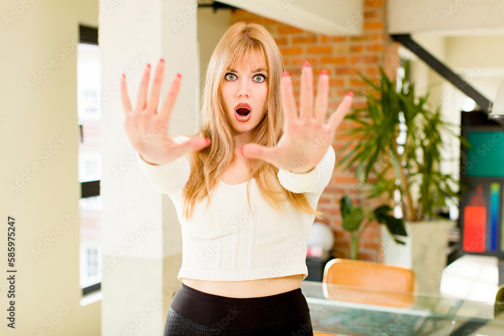 young pretty woman feeling stupefied and scared, fearing something ...