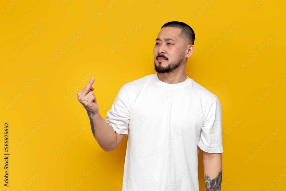 adult rude tattooed asian man in white t-shirt showing middle finger on ...