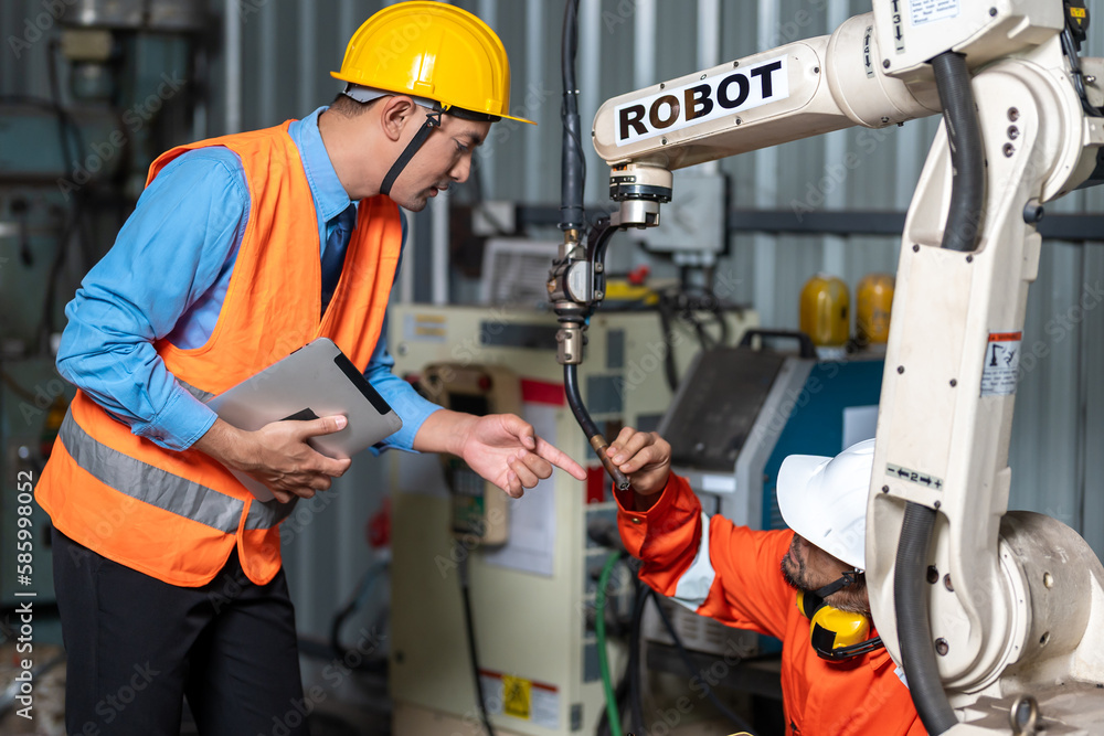 Engineer team service robot welding working in automation factory ...