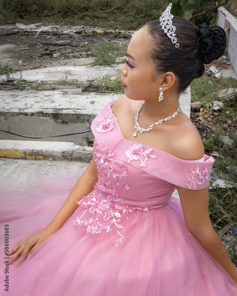 Philippine princess wearing a pink dress and a crown and sitting ...