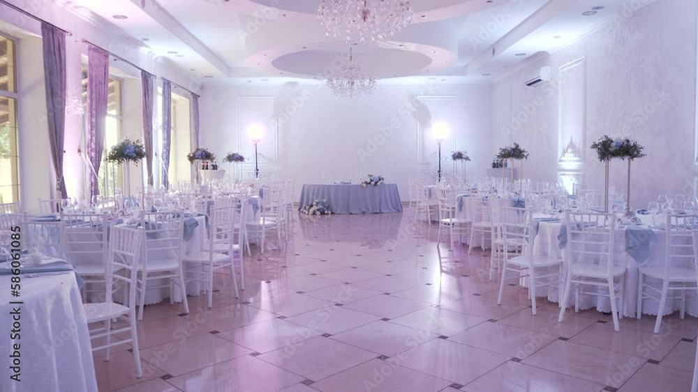 Beautiful rich large banquet hall decorated with flowers with round ...
