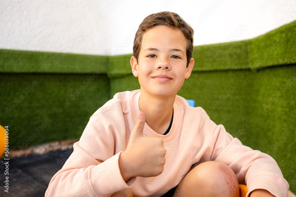 Portrait of attractive happy smiling 11 years old boy, outdoor over ...