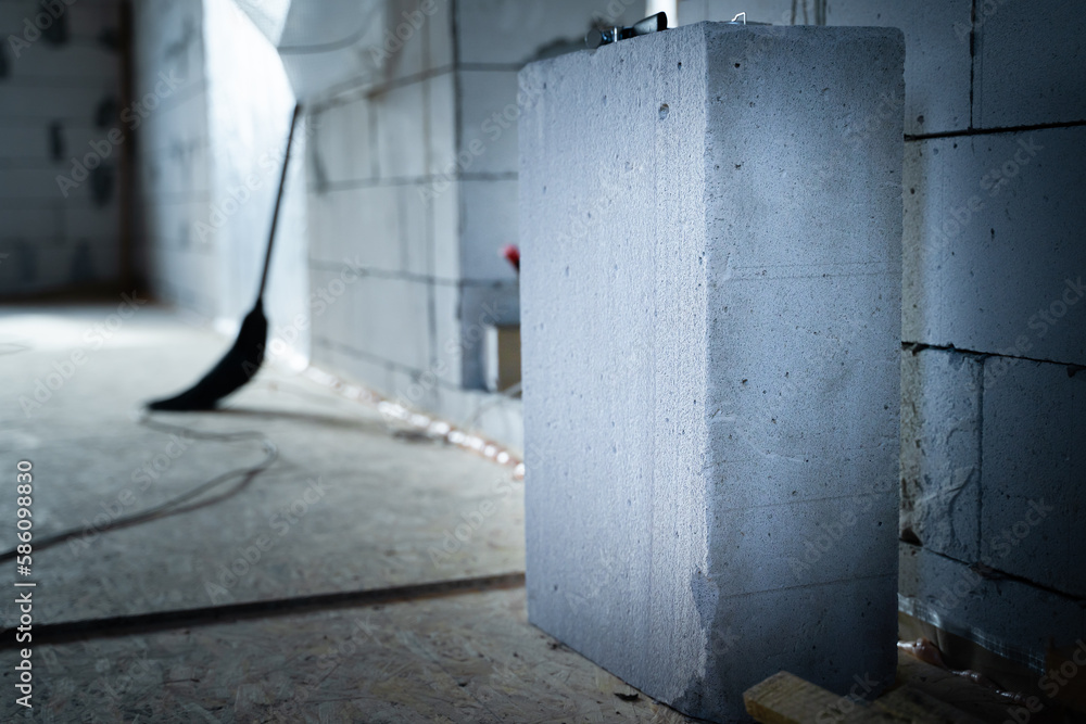 A large aerated concrete brick in a room with bare aerated concrete ...