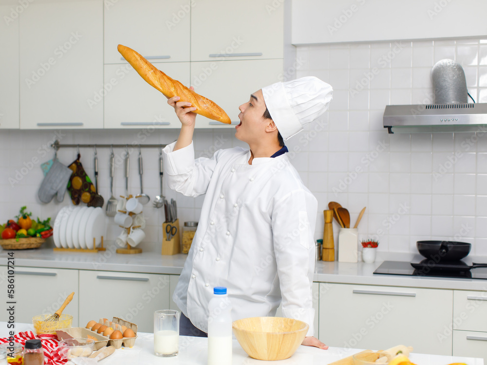 asian professional male pastry chef in white cooking uniform and tall ...