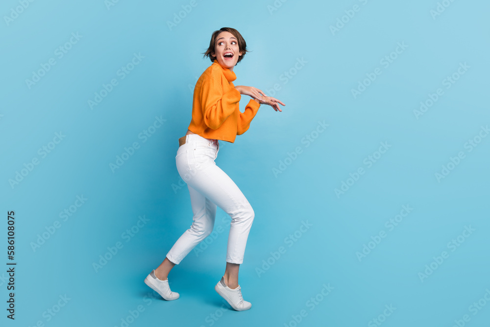 Full size photo of pretty young girl look around sneaking tiptoes play ...