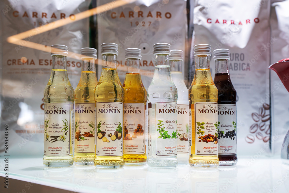 Showcase of a coffee shop with selective focus on the row of syrups ...