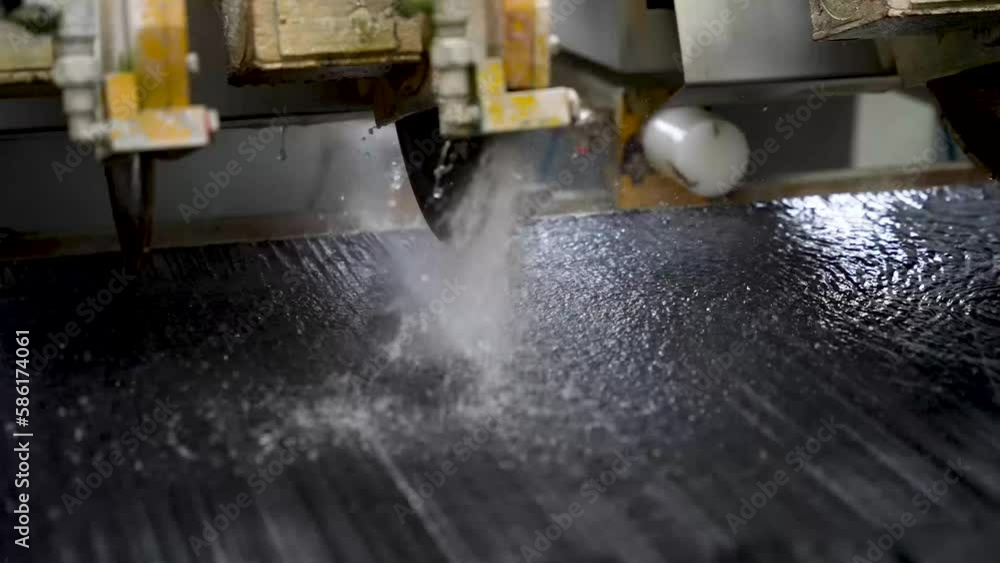 Robotic disc saws creating texture in dark limestone rock, Close up ...