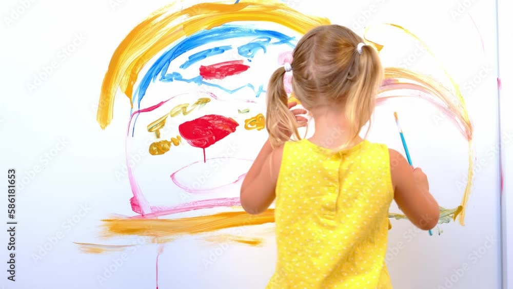 child enthusiastically draws with artistic brush confident strokes ...