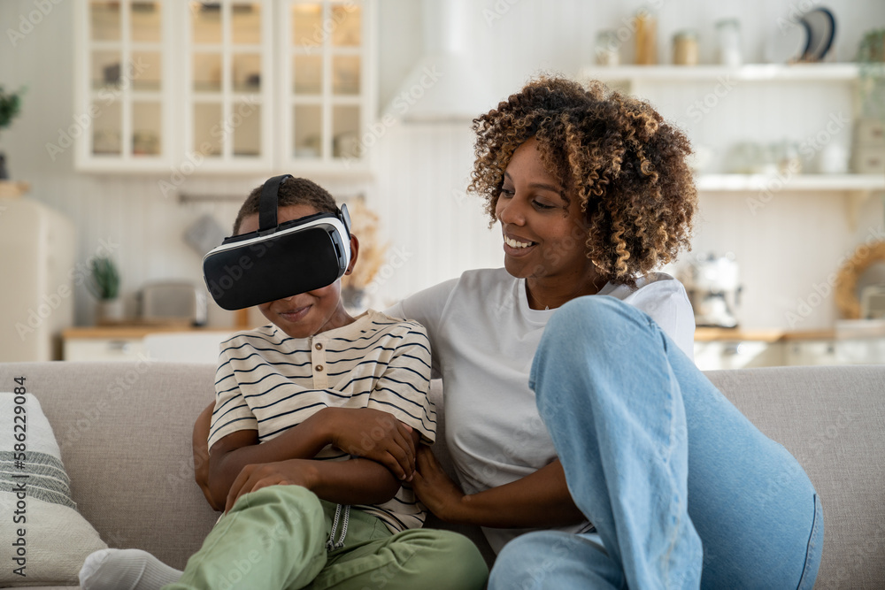 Happy joyful African American family mother and son using VR headset ...