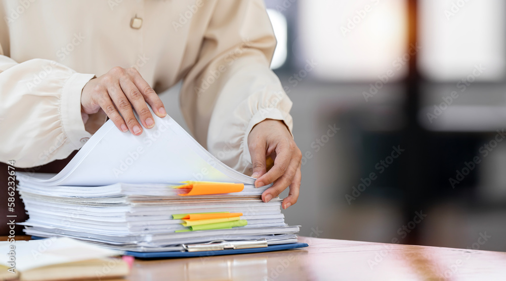 Businesswoman hands working in Stacks of paper files for searching and ...