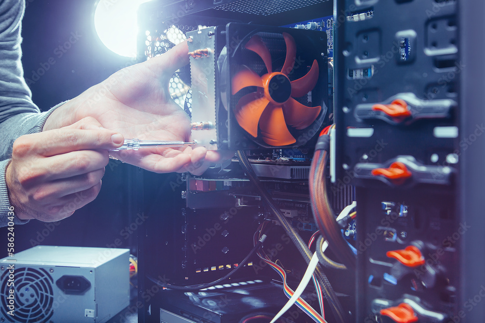 Technician repairing a computer, the process of replacing components on the motherboard. The ...