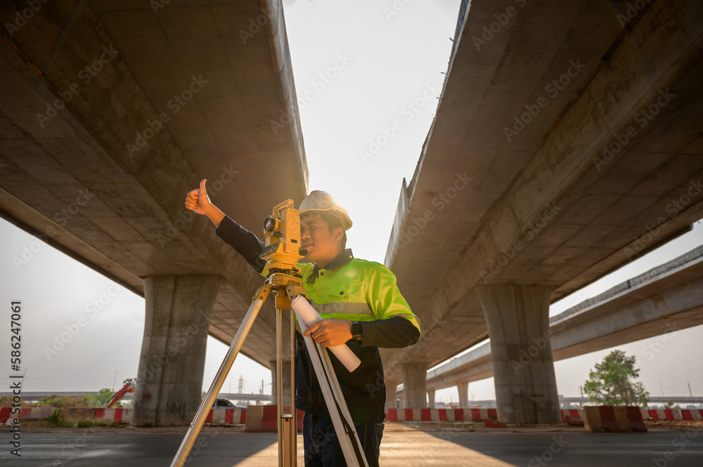 male survey engineer using a theodolite in the construction of a ...