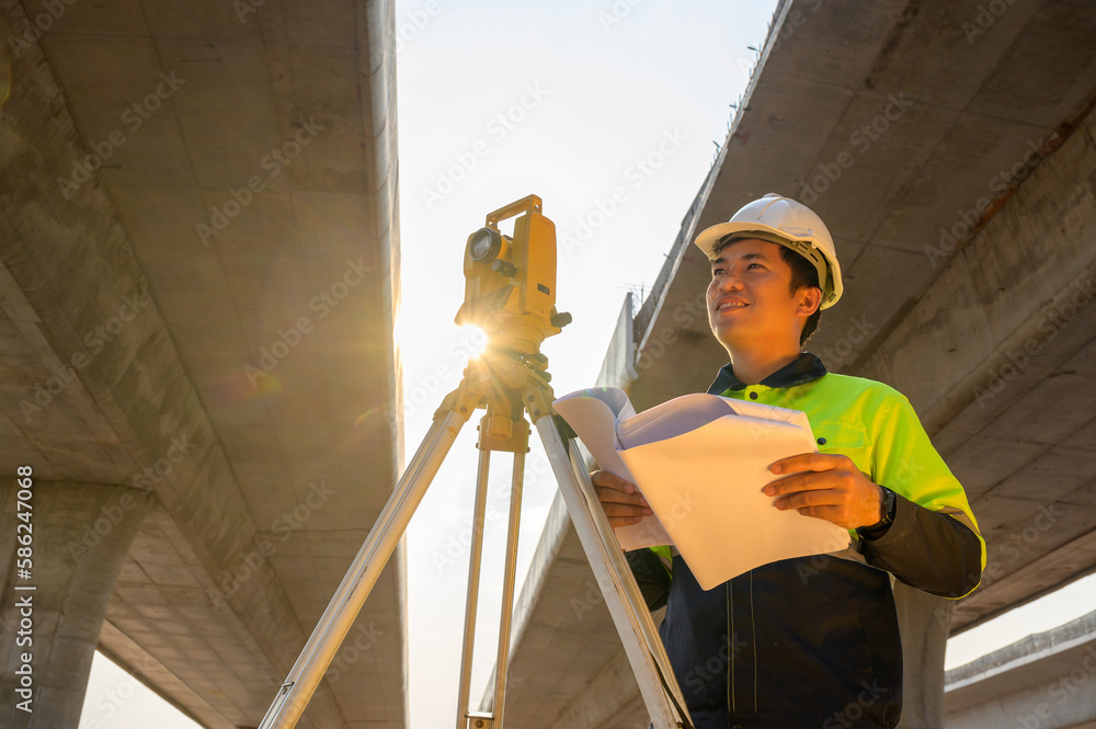 Surveyor Engineer using a theodolite in the construction of a motorway ...