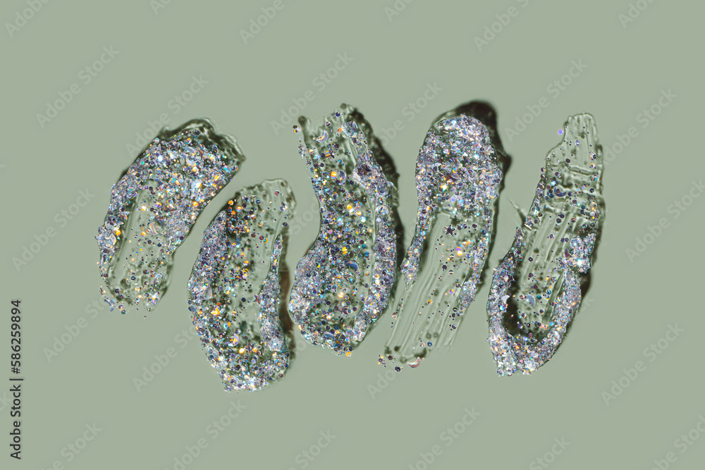 Cosmetic swatches from transparent gel with glitters. Silver glitter ...