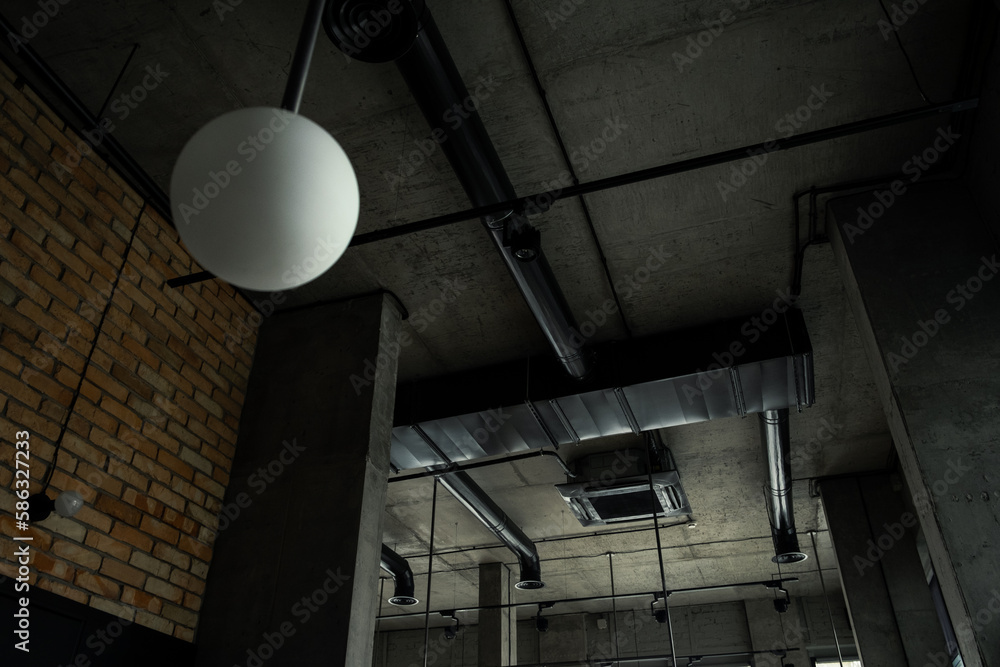 Black ventilation system pipes on the concrete ceiling. Air ...