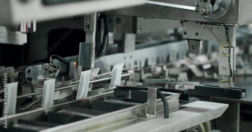 Robotic arm put medicine package on conveyor belt. Packaged goods at ...