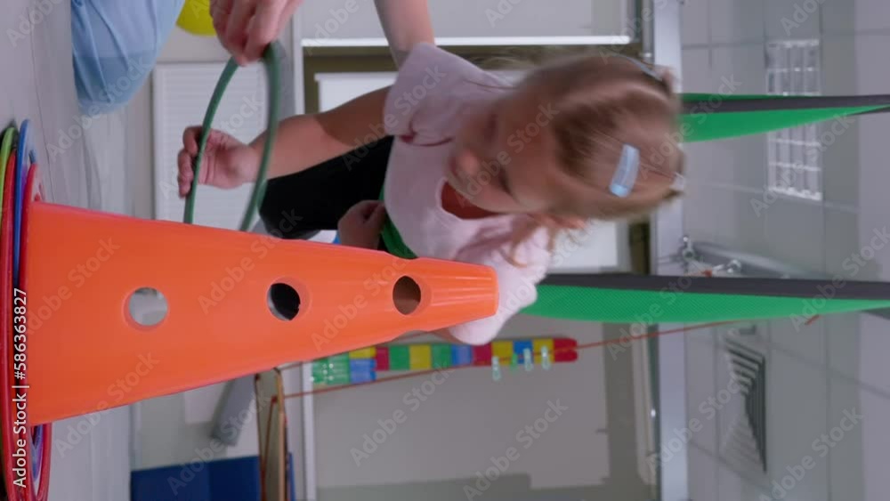Child with physiotherapist on swing during sensory integration session ...