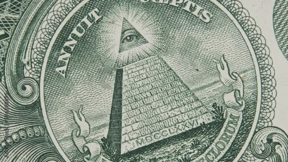 The all-seeing eye sign rotates on a one dollar bill close-up. Mason ...