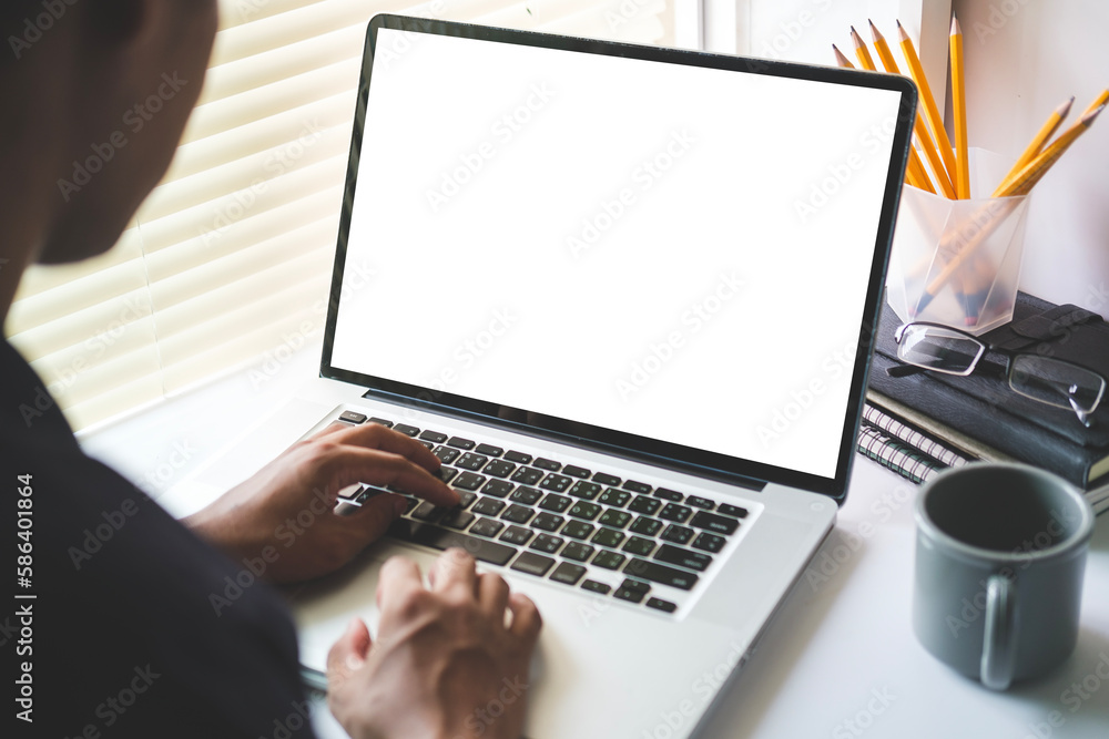 View over man shoulder hands typing on keyboard of laptop computer at ...