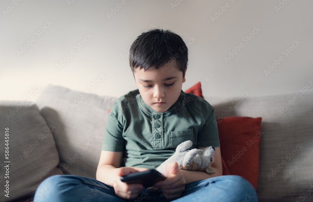 Education concept,School kid using mobile phone readying story from ...