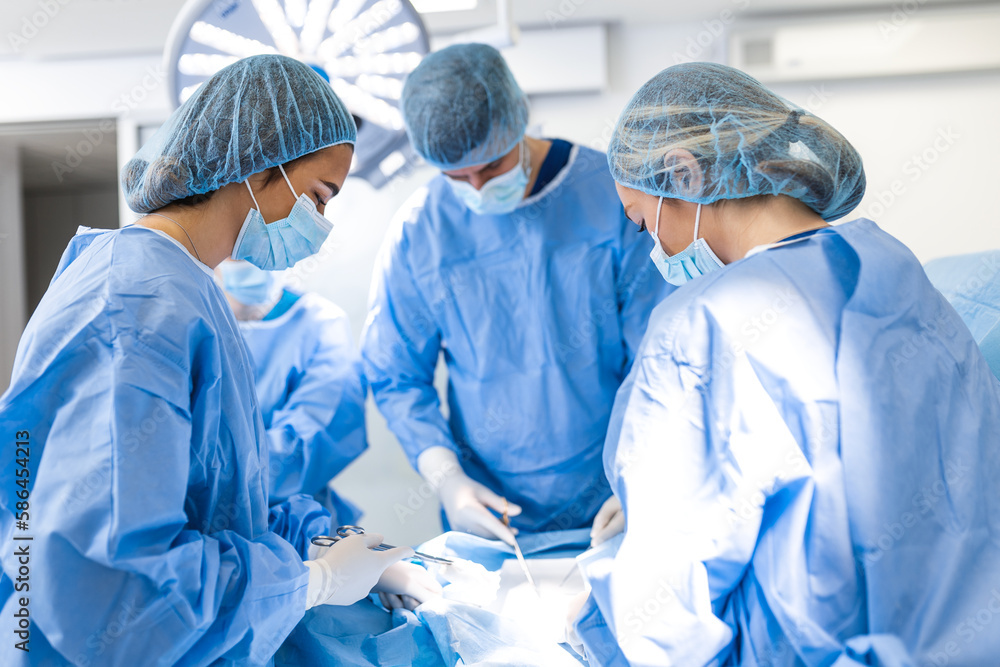 Medical team performing operation. Group of surgeon at work in ...